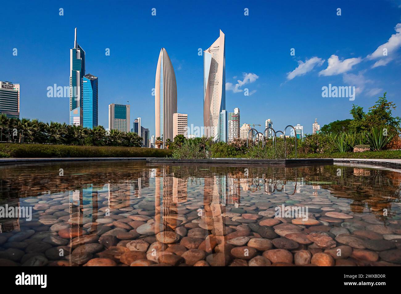 the Al Hamra Tower in Kuwait City photographed from an urban park with ...