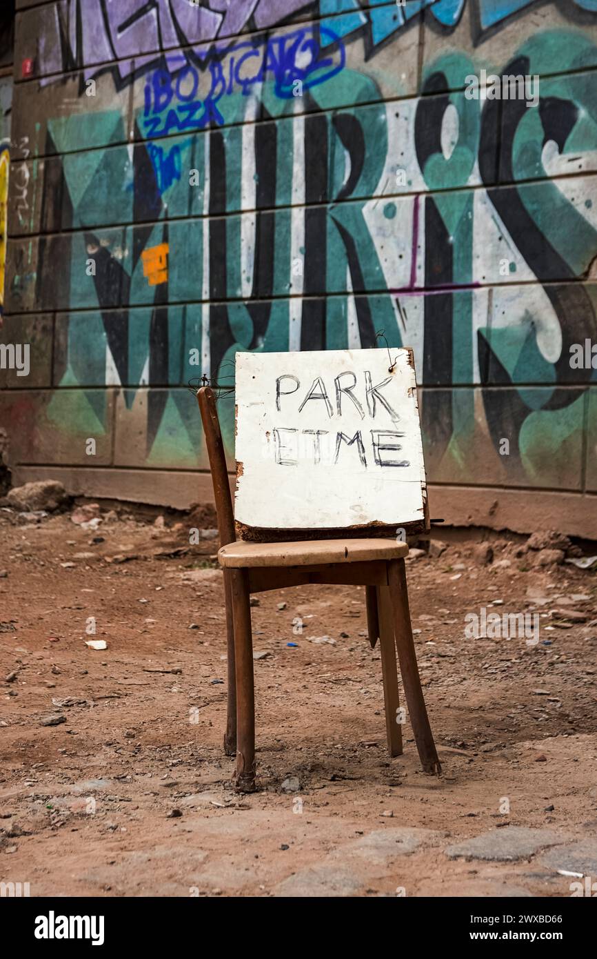 a sign indicating no parking has been placed on an old chair Stock ...