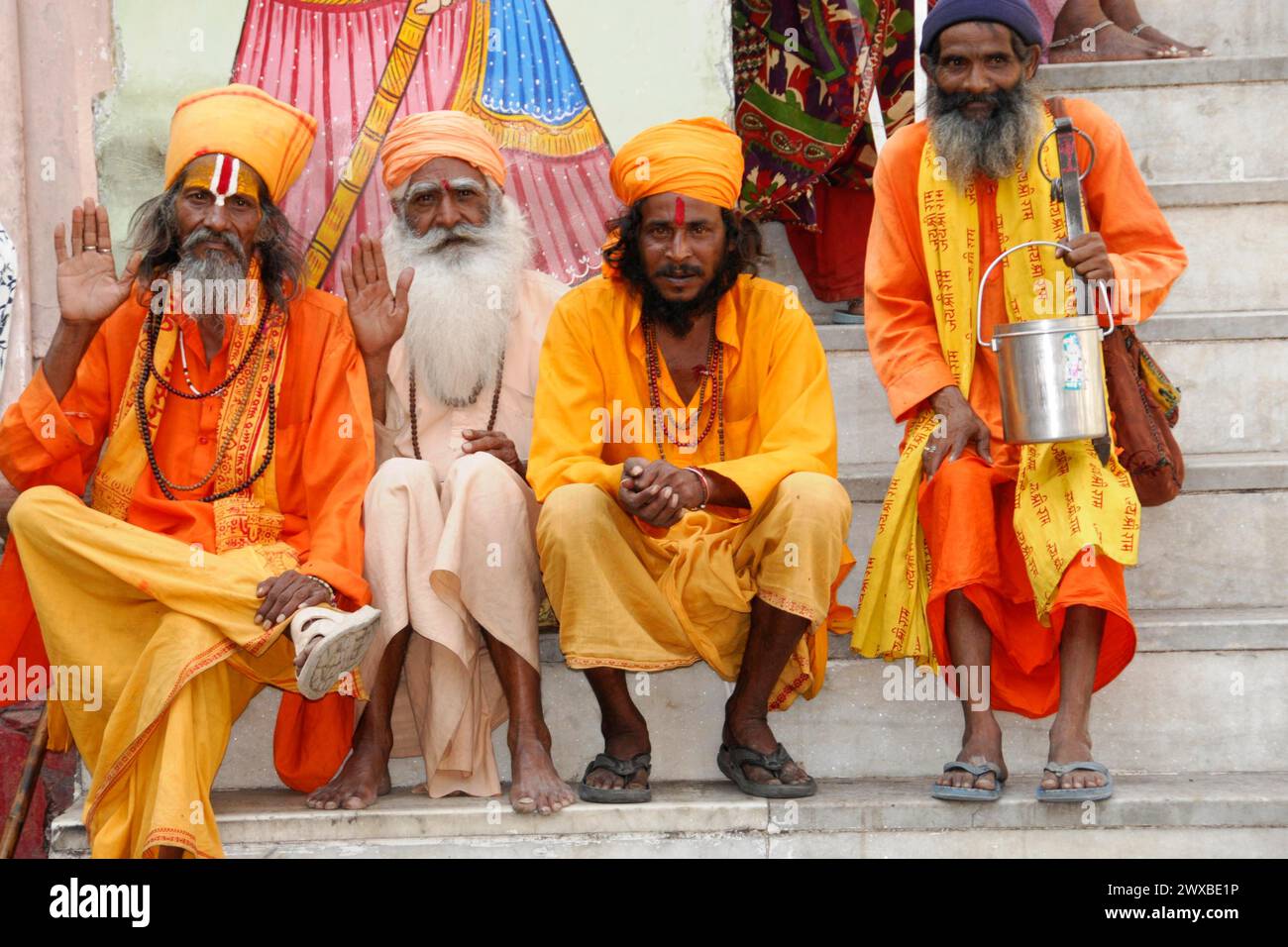 Four seated men in orange robes, recognisable as sadhus, Jaipur ...
