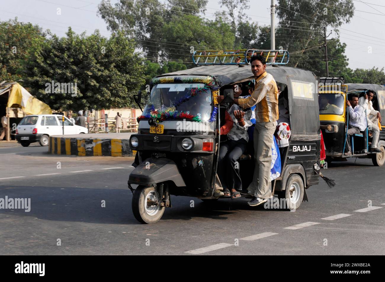A crowded autorickshaw drives through the city, Jaipur, Rajasthan ...