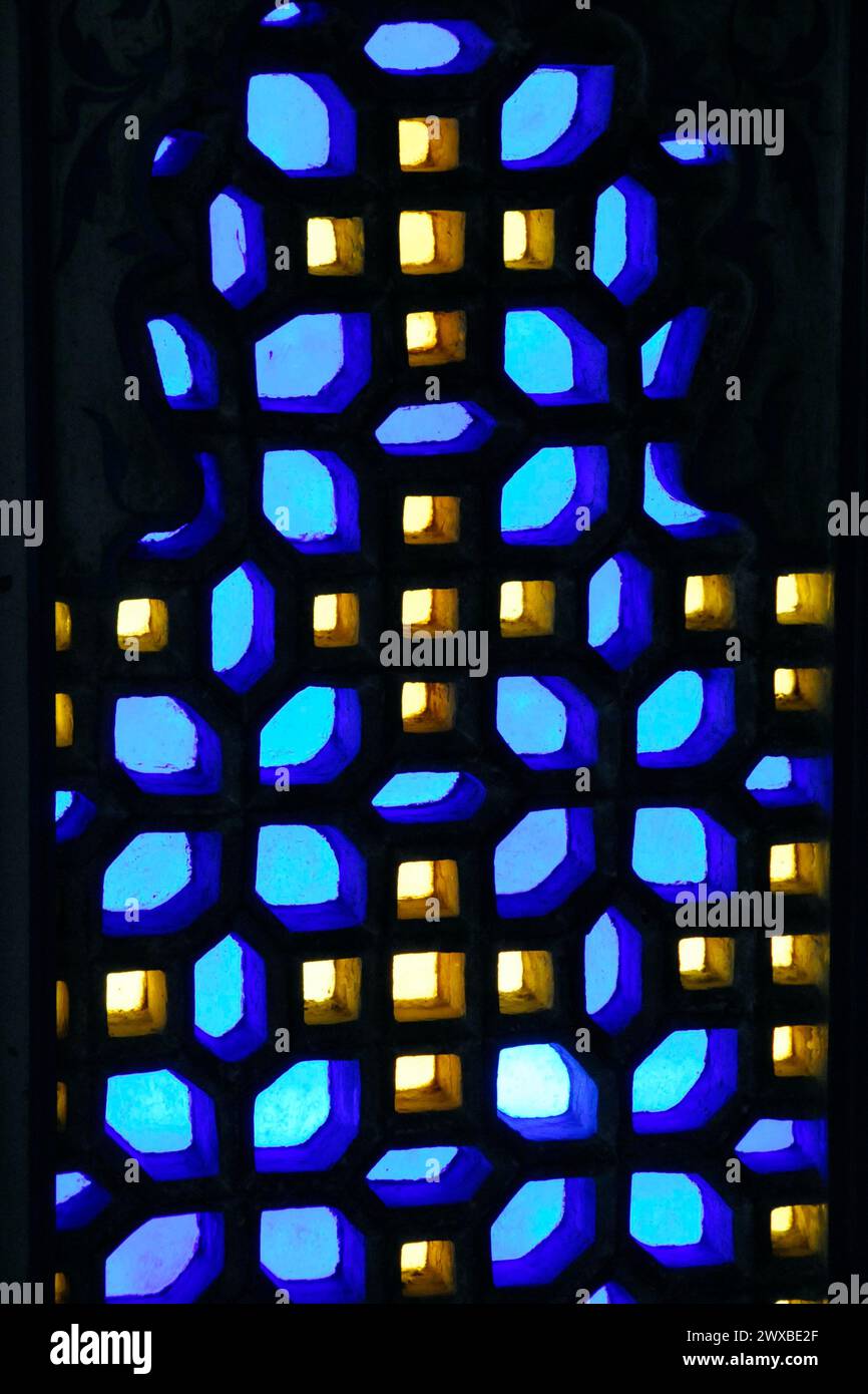 A detail of a blue glass window with geometric patterns, Jaipur ...