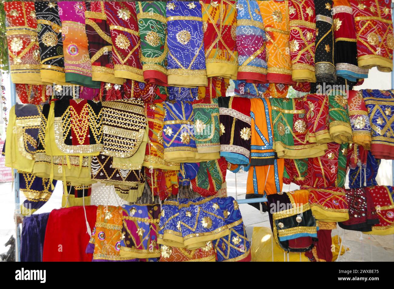Sale, Traditional colourful clothes and textiles displayed at a market ...