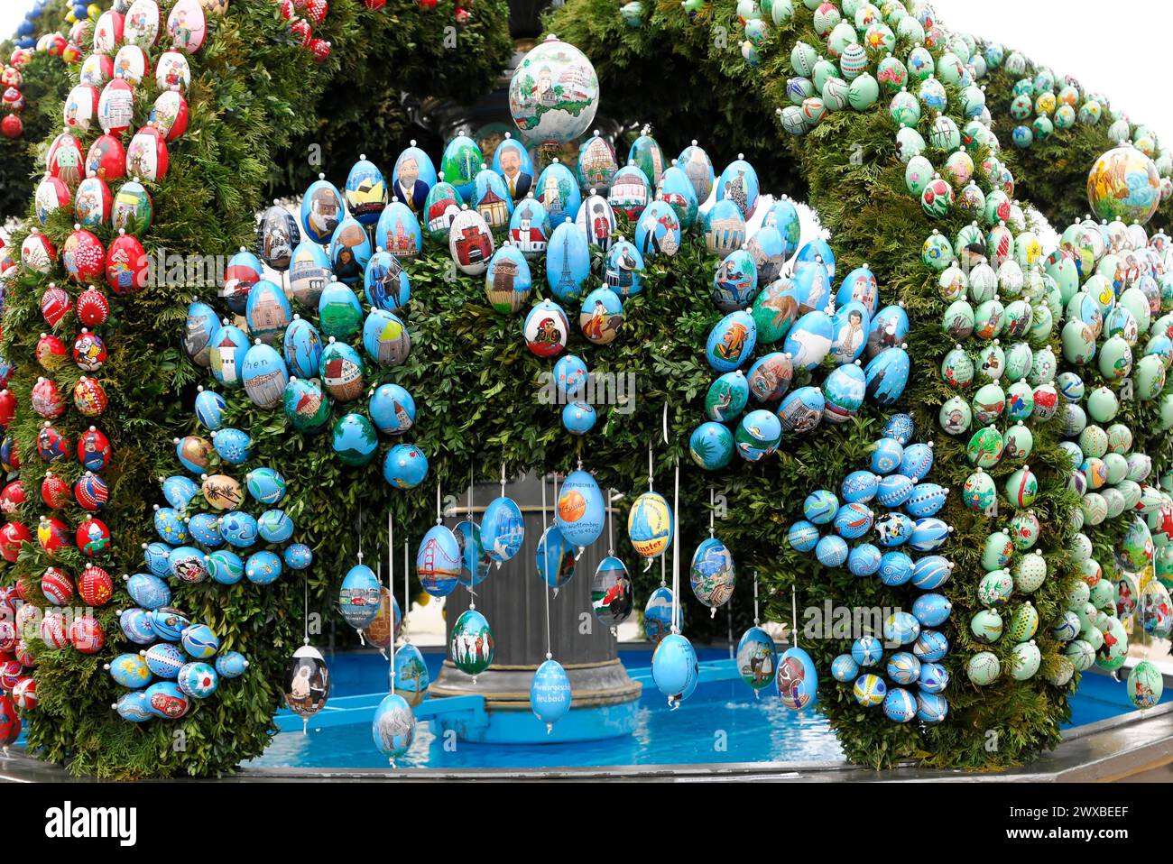 An Easter fountain generously decorated with colourful Easter eggs in a ...