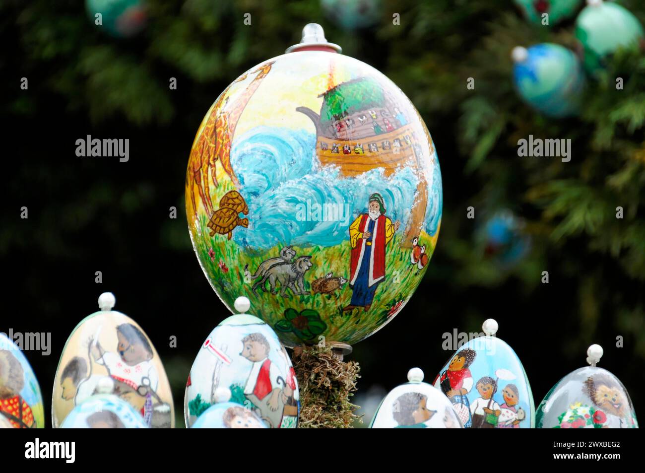A large, round Easter egg shows a painted landscape with landmarks ...