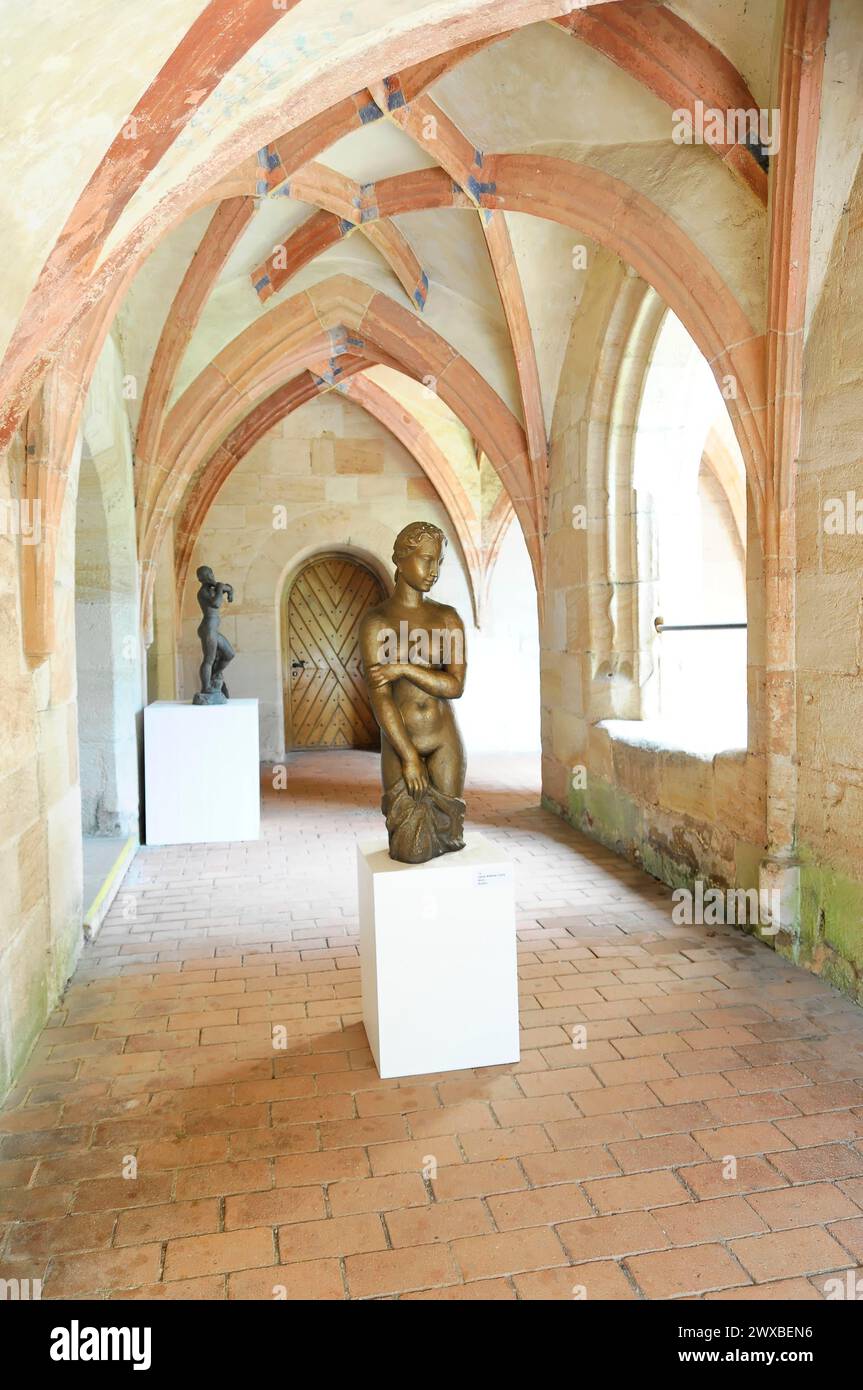 Two modern sculptures on pedestals in a vaulted church aisle, Lorch ...
