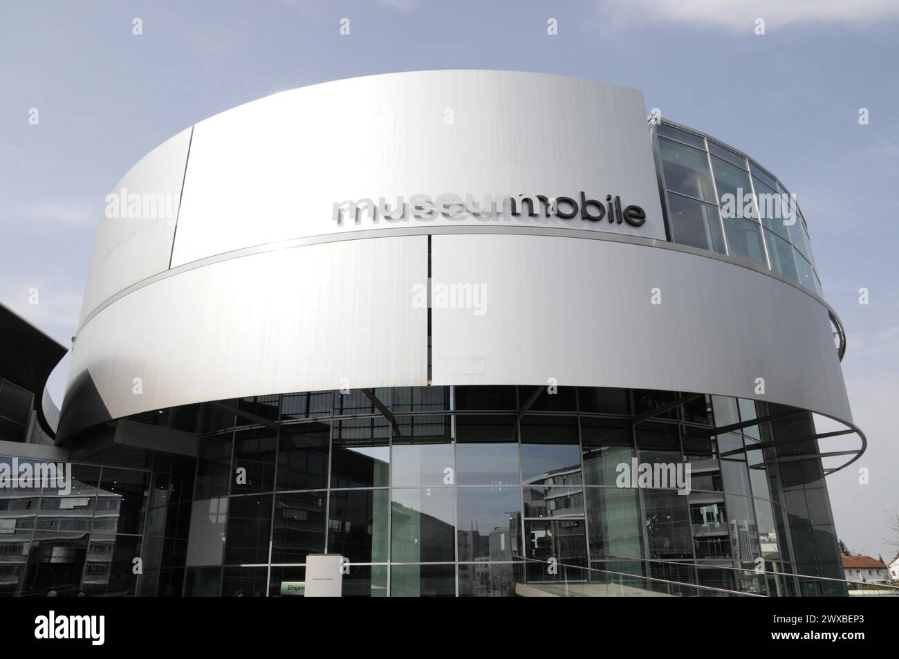 Modern museum mobile building with reflective glass facade and clear ...
