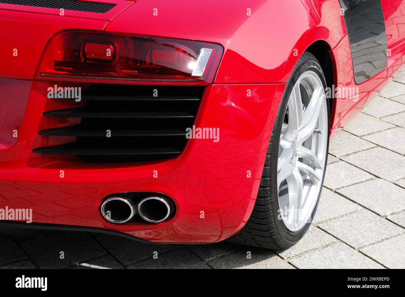 Rear view of a red sports car with distinctive air vents and exhaust ...