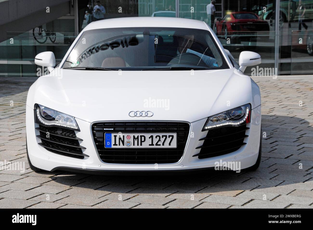 A white Audi R8 with open door parked on a paved area, Museum mobile ...