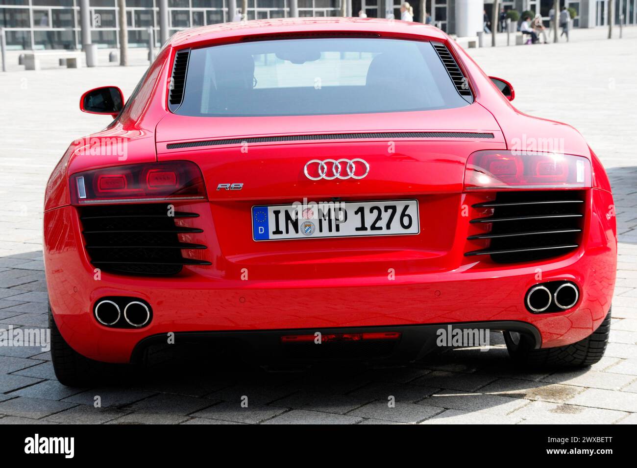 Red Audi sports car rear view with visible number plate on a car park ...