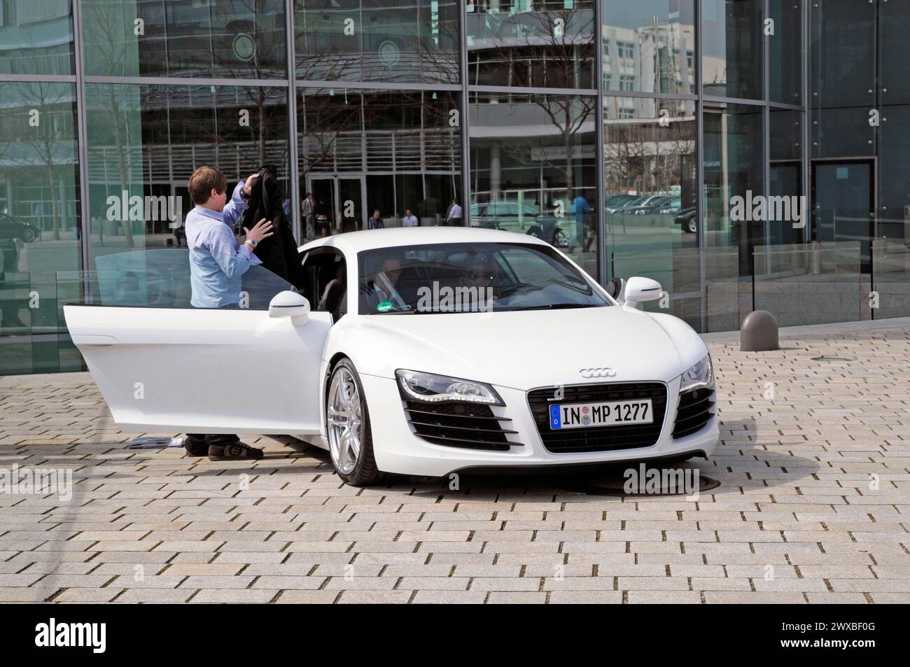 Museum mobile, Audi Museum, Man opens the door of a white Audi sports ...