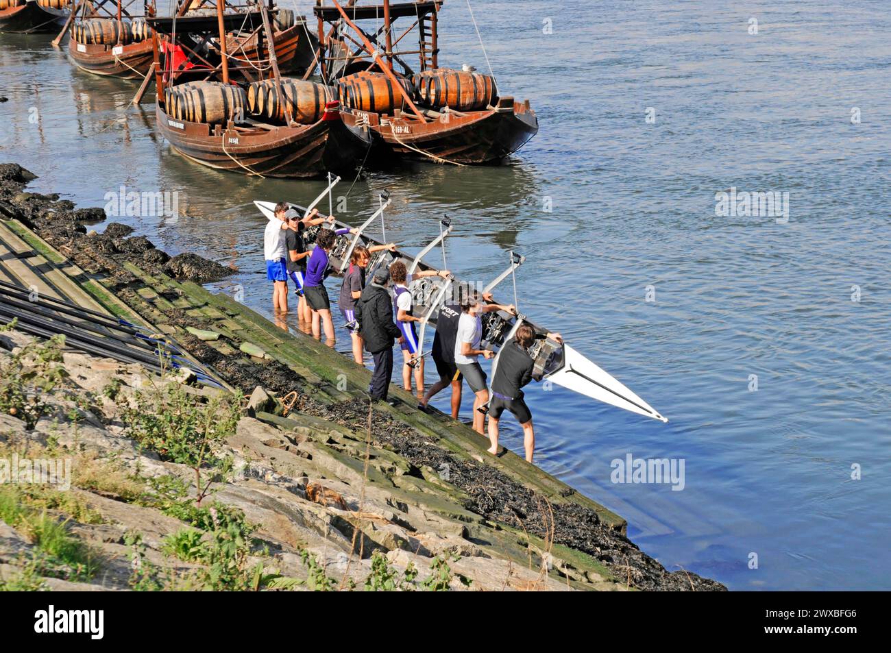Ruserteam lifts a boat into position to launch it into the water, Douro ...