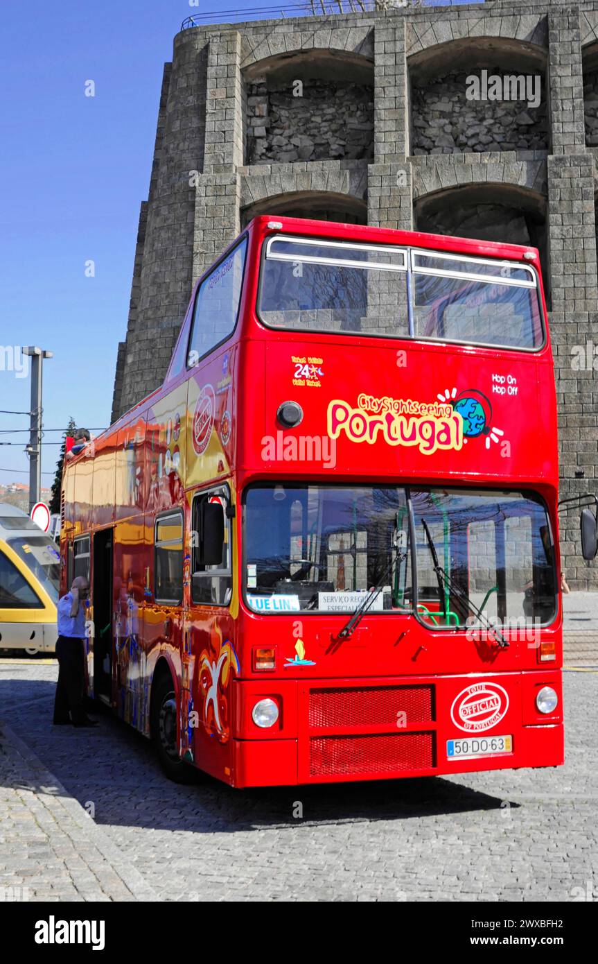 Red sightseeing double-decker bus in an urban environment in Portugal ...