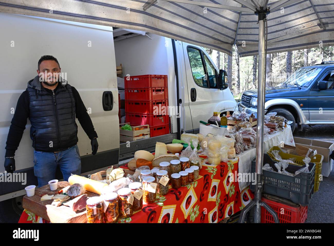 Lorica, Italy - March, 2024: Vendor behind counter with meat and ...