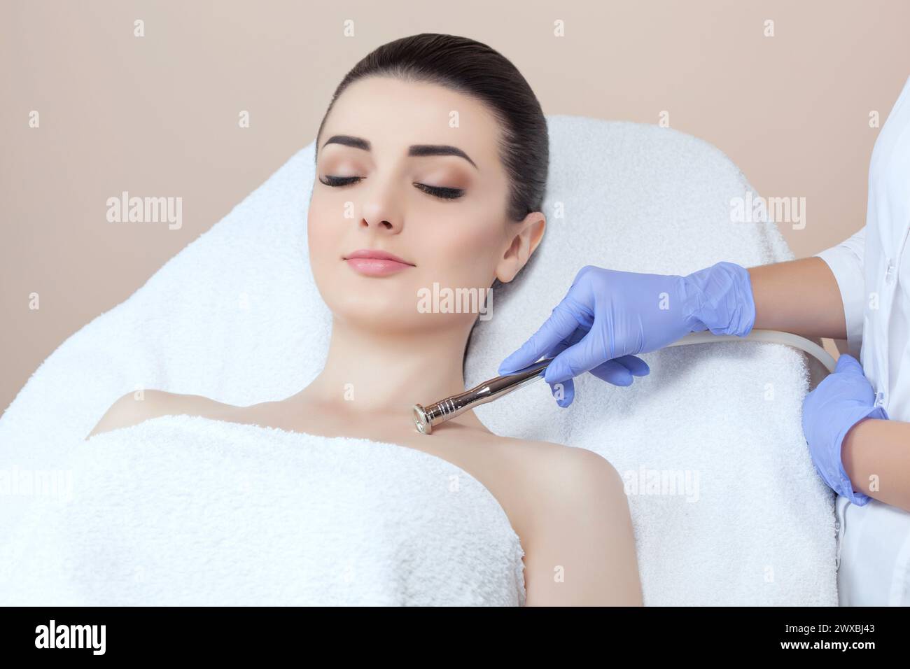 The cosmetologist makes the procedure Microdermabrasion of the ...