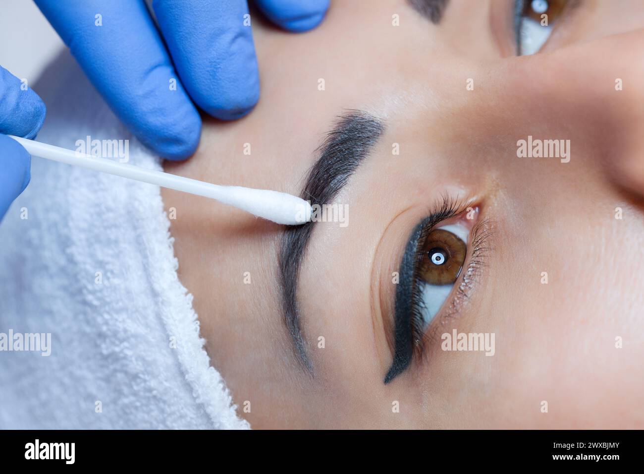 Permanent make-up for eyebrows of beautiful woman with thick brows in ...