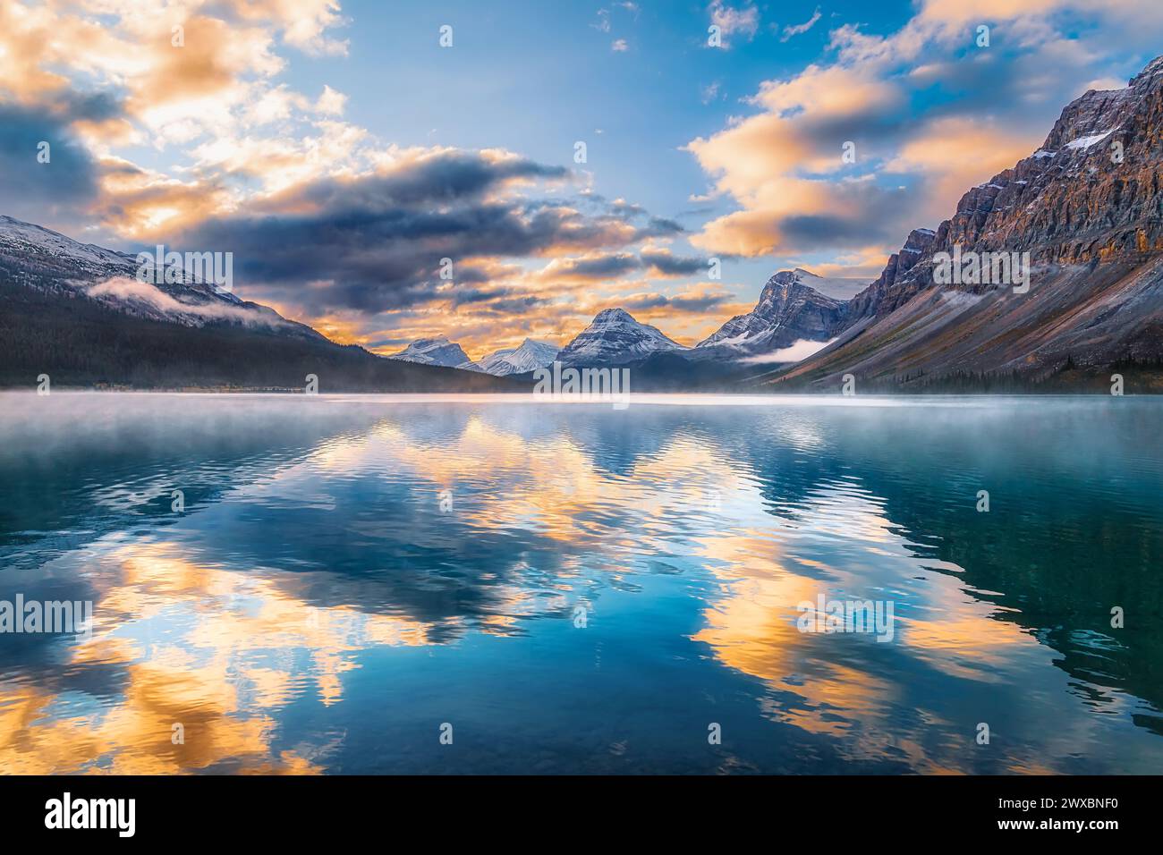 Warm Sunrise Reflections At A Banff Mountain Lake Stock Photo - Alamy