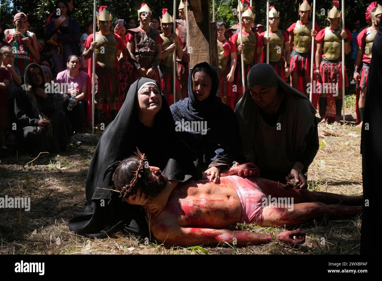 Actors perform in a Way of the Cross reenactment as part of Holy Week ...