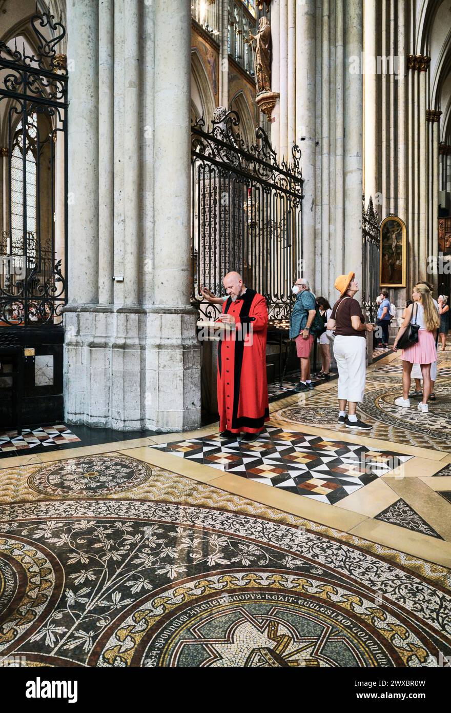 Cologne Cathedral supervisory steward with red robe surrounded by ...