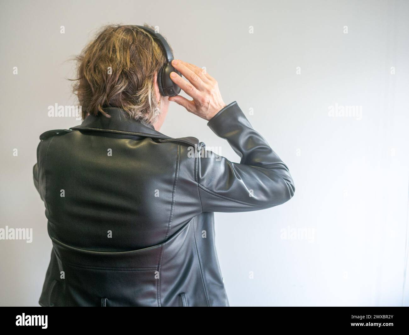 portrait of an unrecognizable lady from behind wearing a leather jacket ...