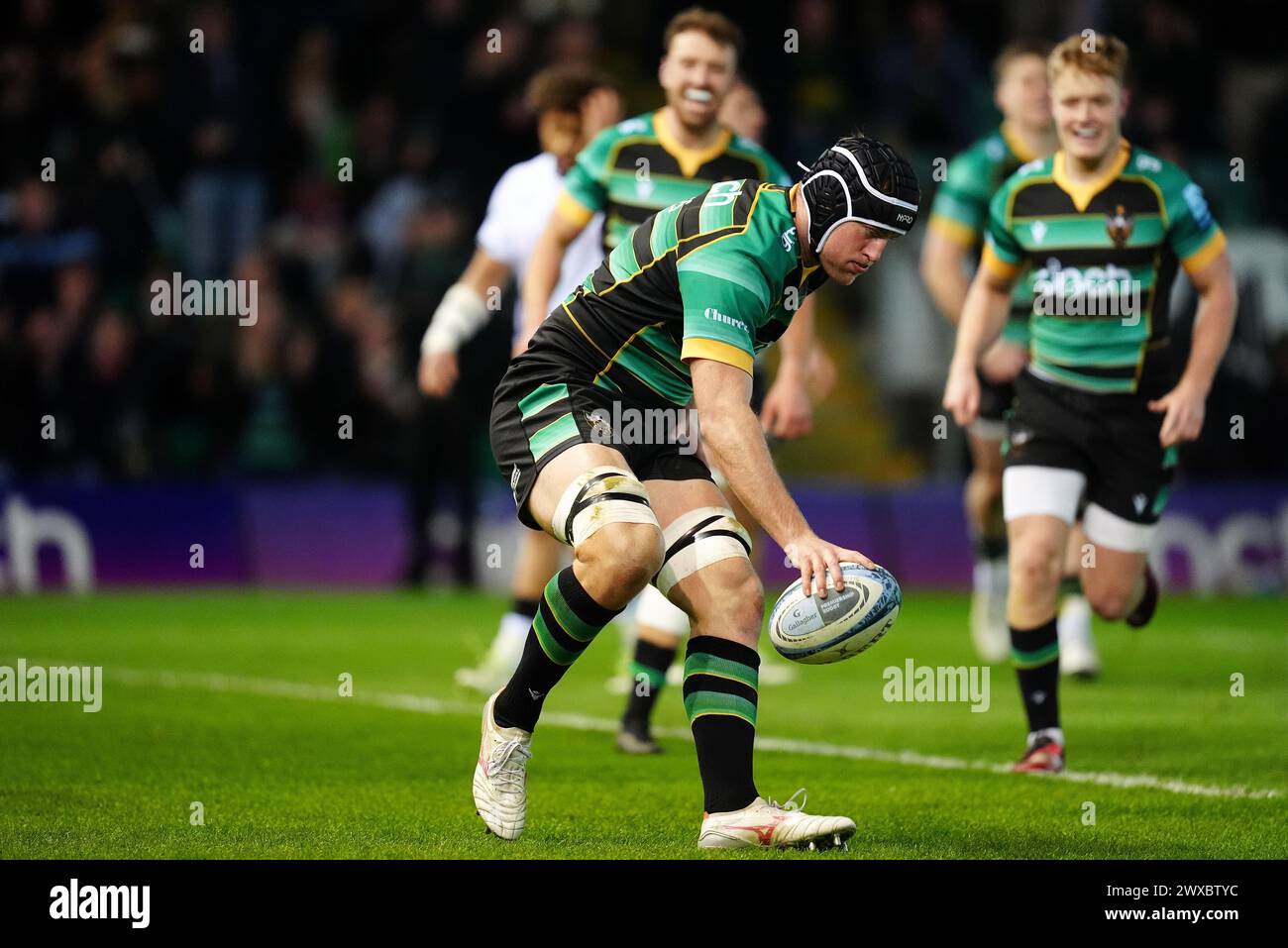 Northampton Saints' Alex Coles scores the opening try of the game ...