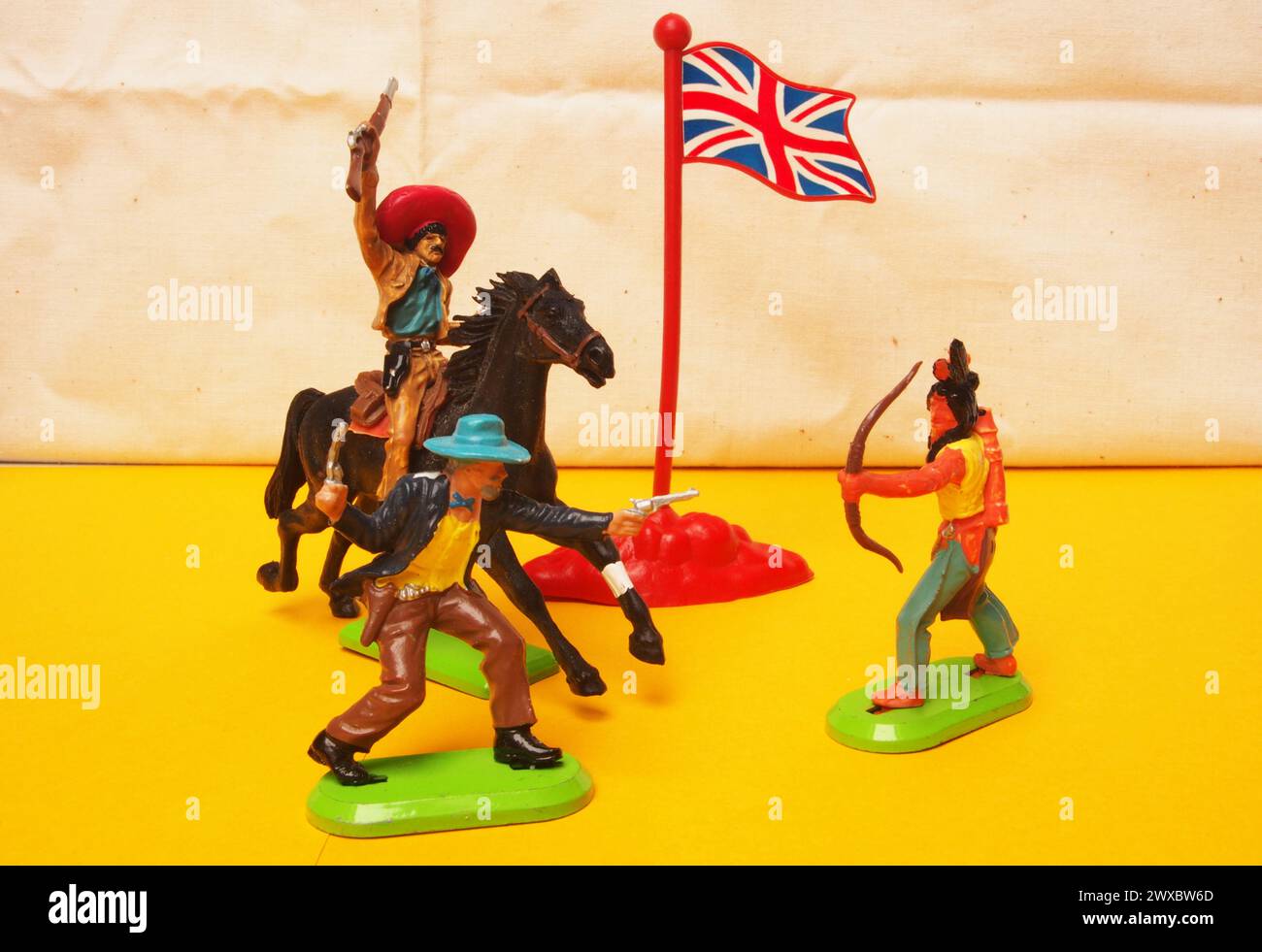 Retro toys of cowboys and red Indians with a Union Jack flag Stock ...