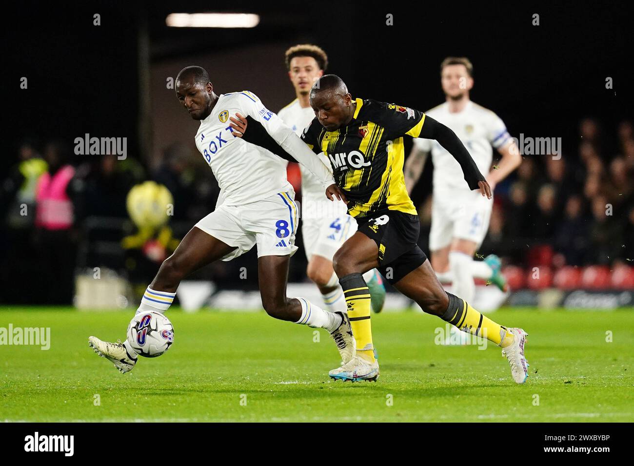 Leeds United's Glen Kamara (left) and Watford’s Edo Kayembe battle for ...