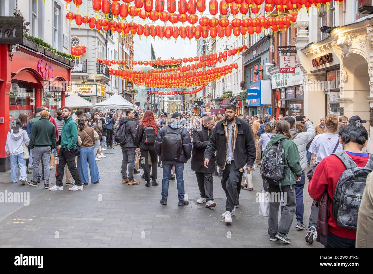 Wardour Street in Chinatown, London, bustling with crowds of shoppers ...