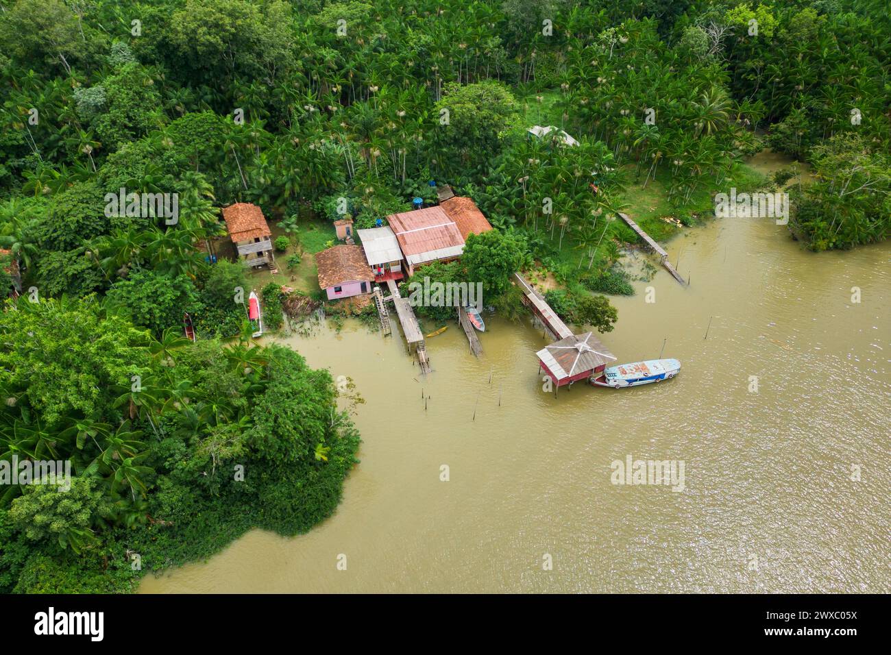 Aerial View of a Small Community Houses in Tropical Rainforest by the ...