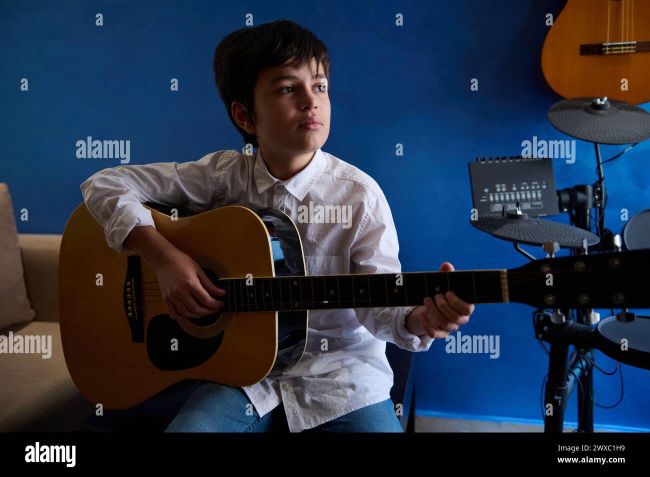 Serious adolescent boy performing sound melody, singing song while ...
