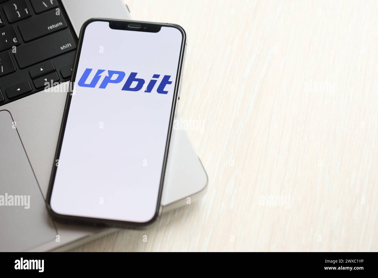 KYIV, UKRAINE - MARCH 15, 2024 Upbit logo on iPhone display screen on ...