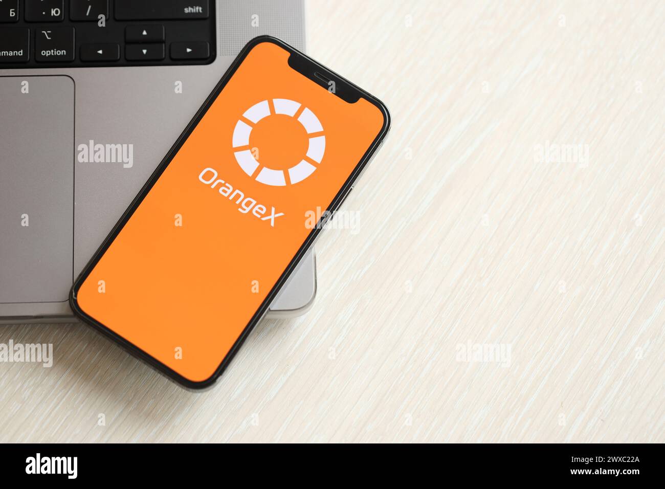 KYIV, UKRAINE - MARCH 15, 2024 OrangeX logo on iPhone display screen on ...