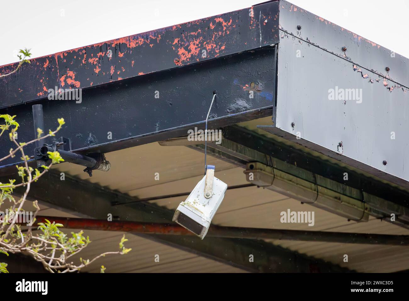 Speaker at a football stadium hanging by its wire after the bracket has ...