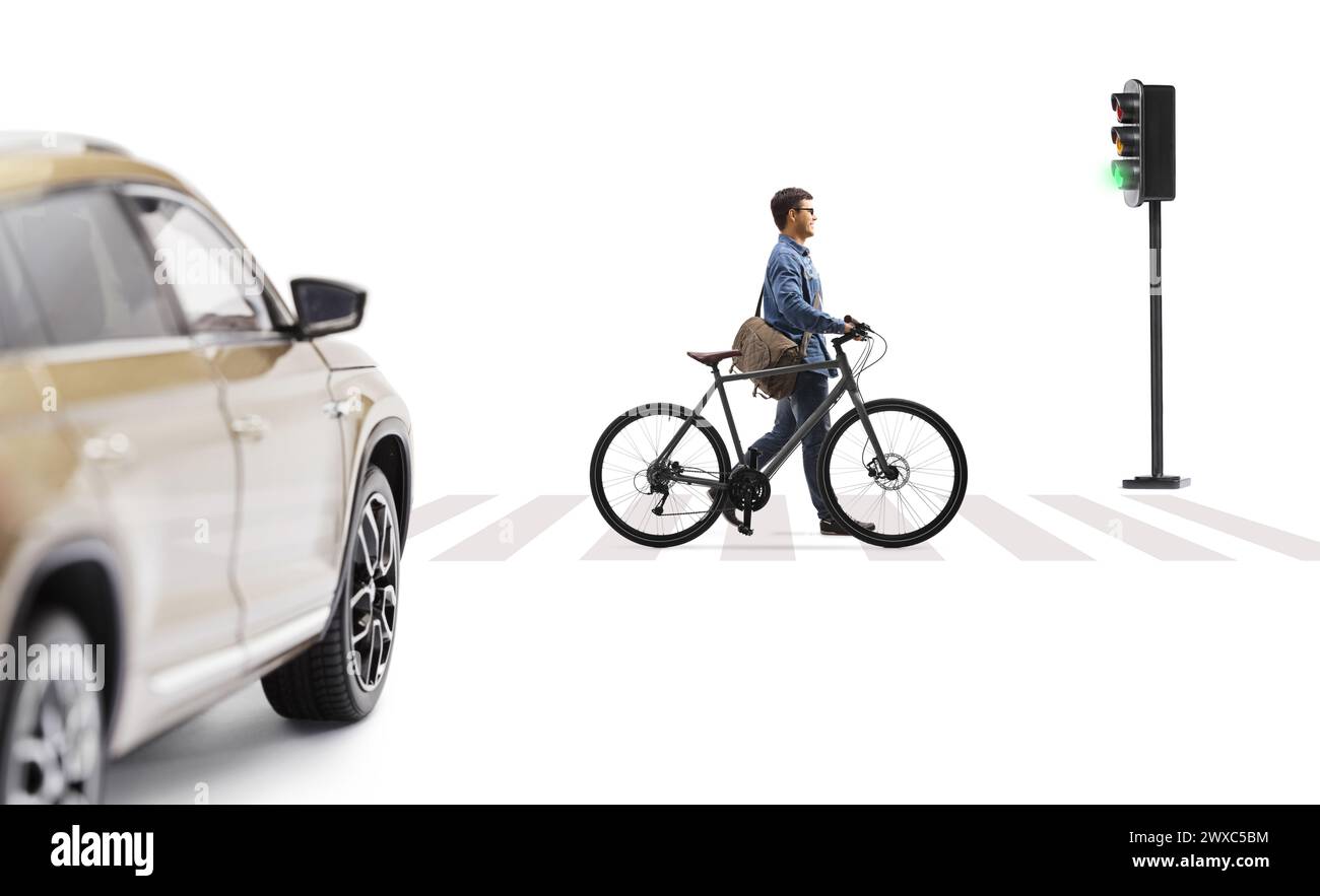 Full length profile shot of a guy pushing a bicycle in front of a car ...