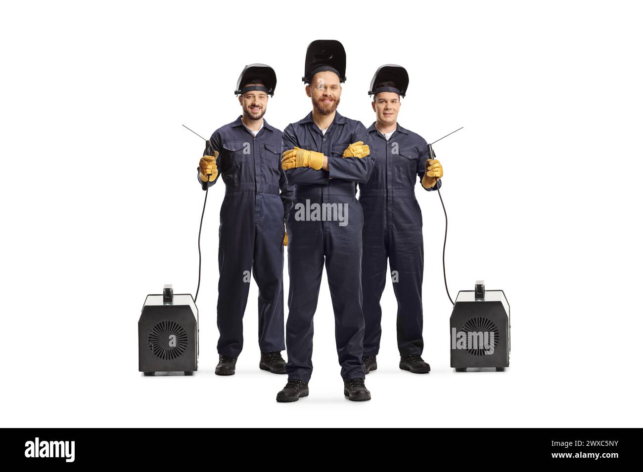 Full length portrait of a group of welders with welding machines ...