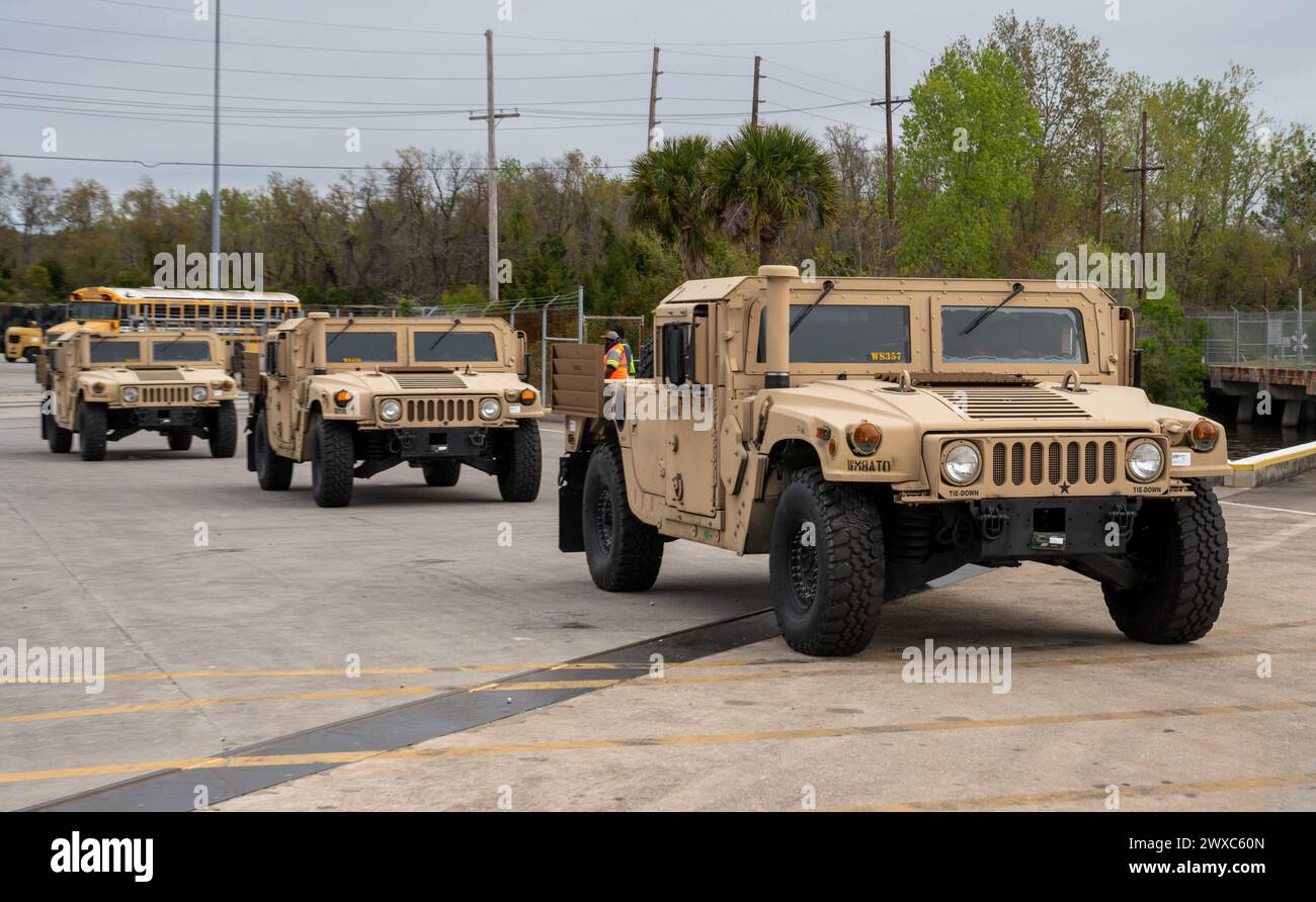 Three U.S. Army Humvees prepare to board the USNS Charlton at Joint ...