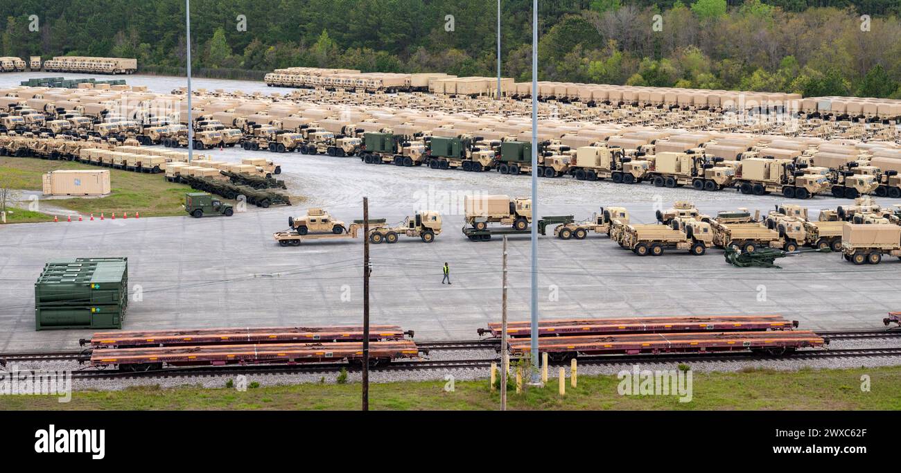 U.S. Army vehicles and equipment are staged, ready to be loaded onto ...