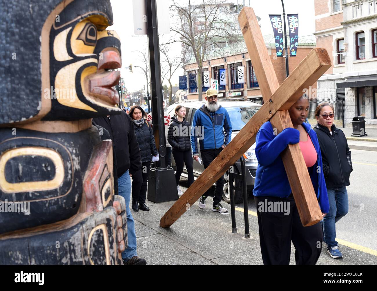 Victoria, British Columbia, Canada, March 29, 2024 - A woman carries a ...