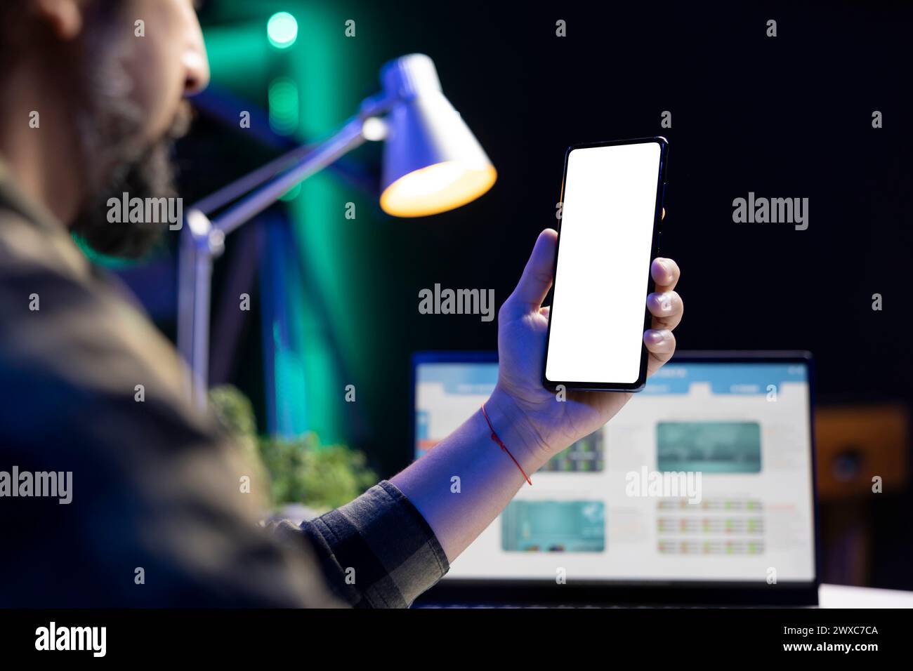 Man vertically holding mobile device with isolated copyspace mockup ...