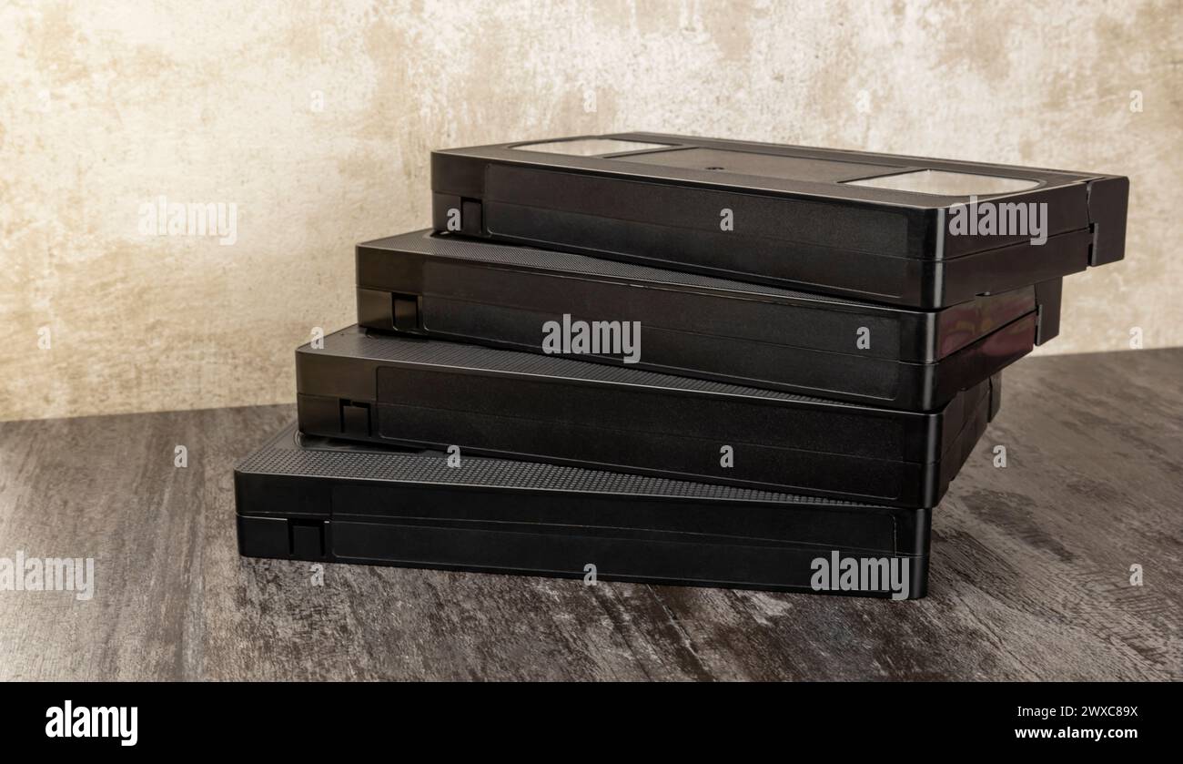 VHS video cassettes are stacked on top of each other. The concept of ...