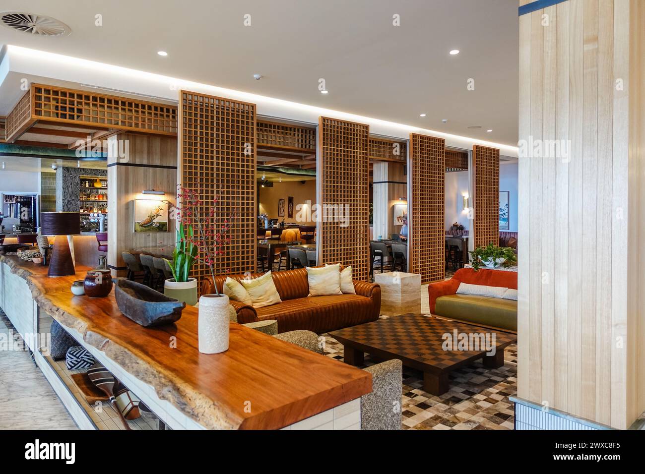 Modern hotel lobby with comfortable seating and decorative wooden ...