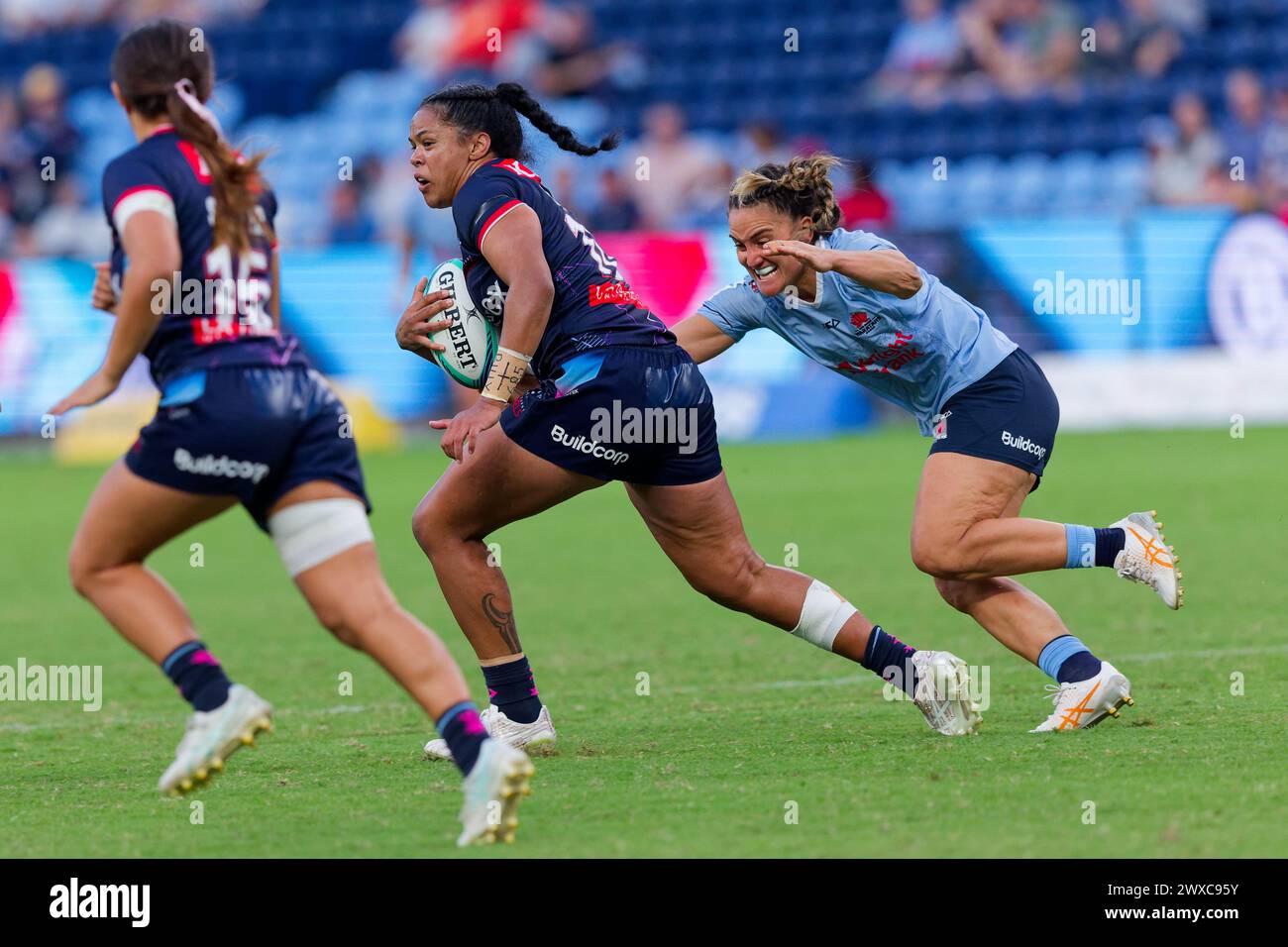 Katrina Barker of the Waratahs prepares to tackle Cassie Siataga of the ...