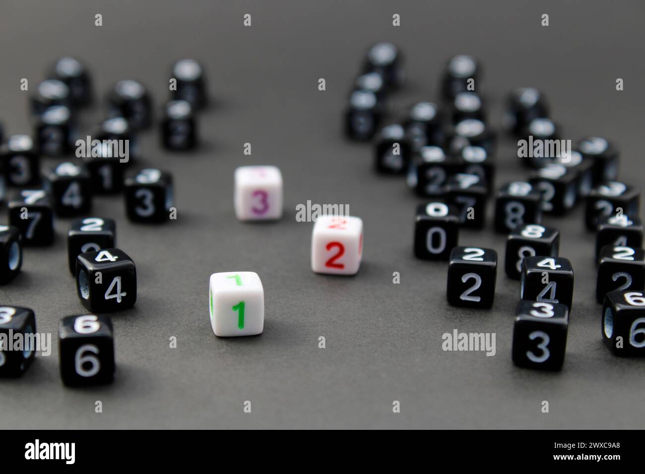 Three cubes with numbers that differ from the group by their color ...