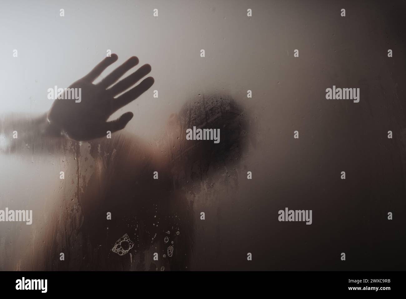 Silhouette of a person behind a steamy glass with hand print Stock Photo - Alamy