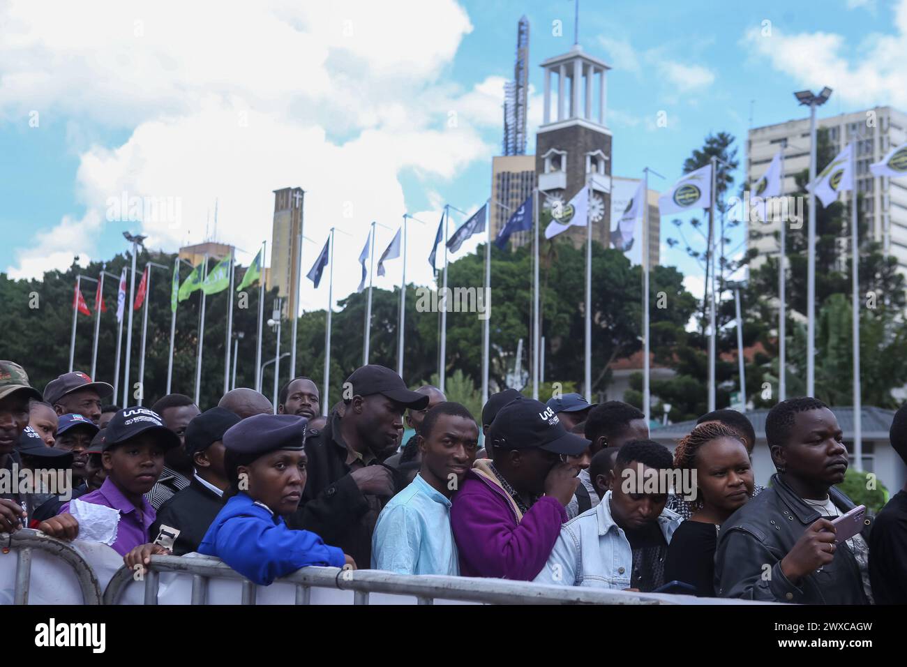 Kenyans line up to get autographs from rally drivers during the official flagging off ceremony ...