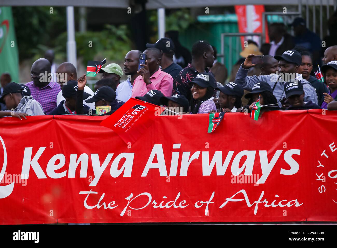 Kenyan and international fans cheer rally drivers during the official ...