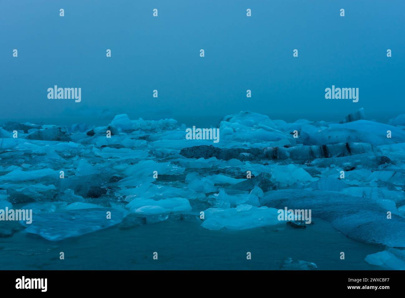 Floating iceberg of the Jokulsarlon Glacier Lagoon under heavy rain ...