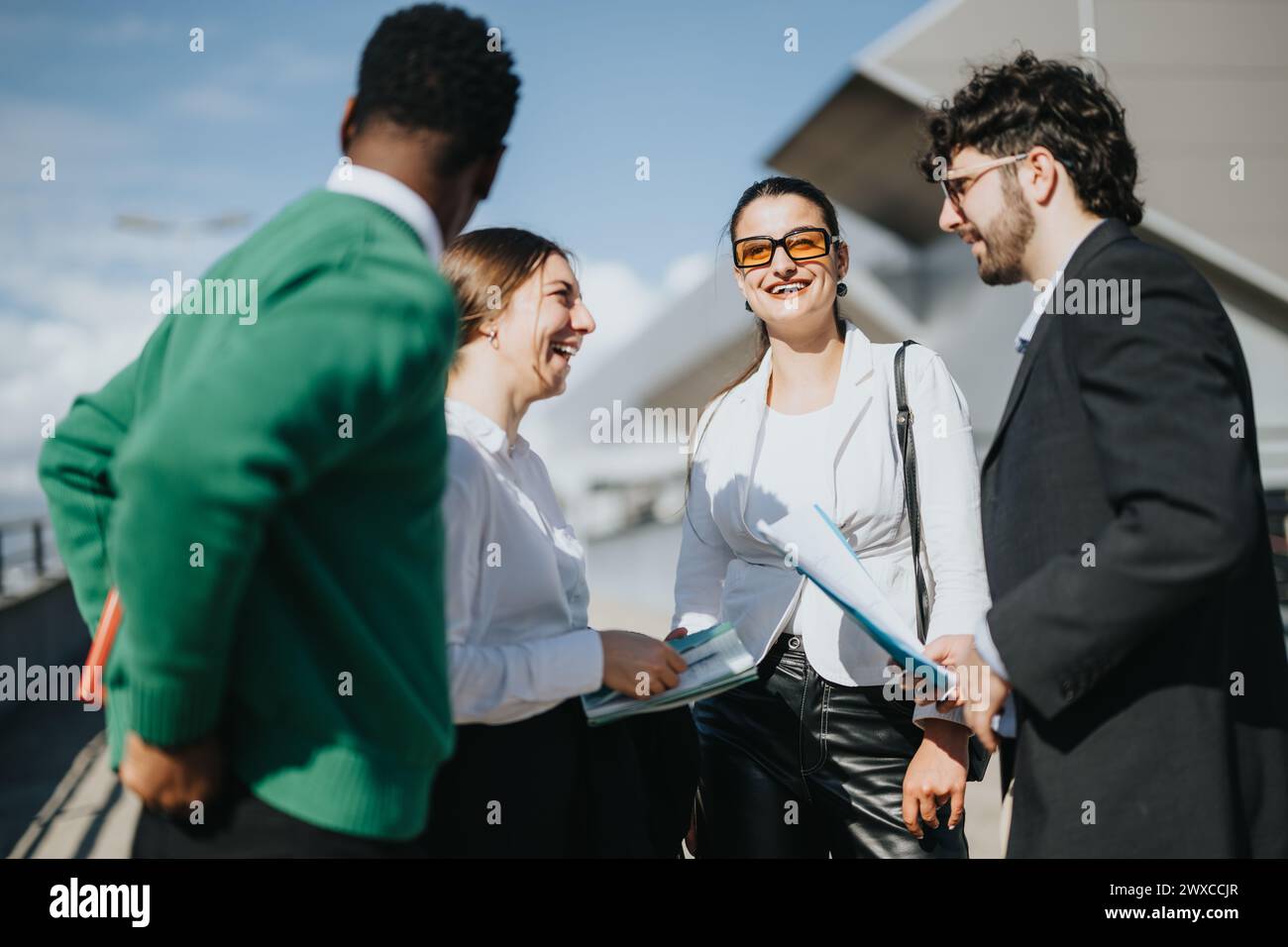 Multicultural business team discussing strategy in an outdoor setting ...