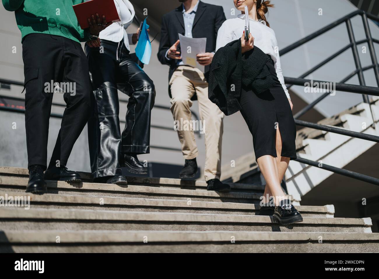Multicultural business team discussing strategy on office steps Stock Photo - Alamy