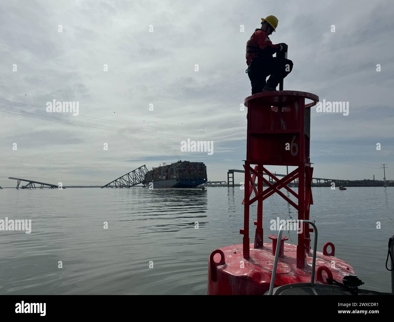 Petty Officer 2nd Class Collin Brayerton, a crewmember from Coast Guard ...
