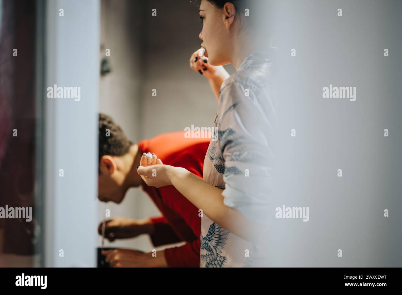 Everyday life scene with a couple in a kitchen, engaging in morning ...